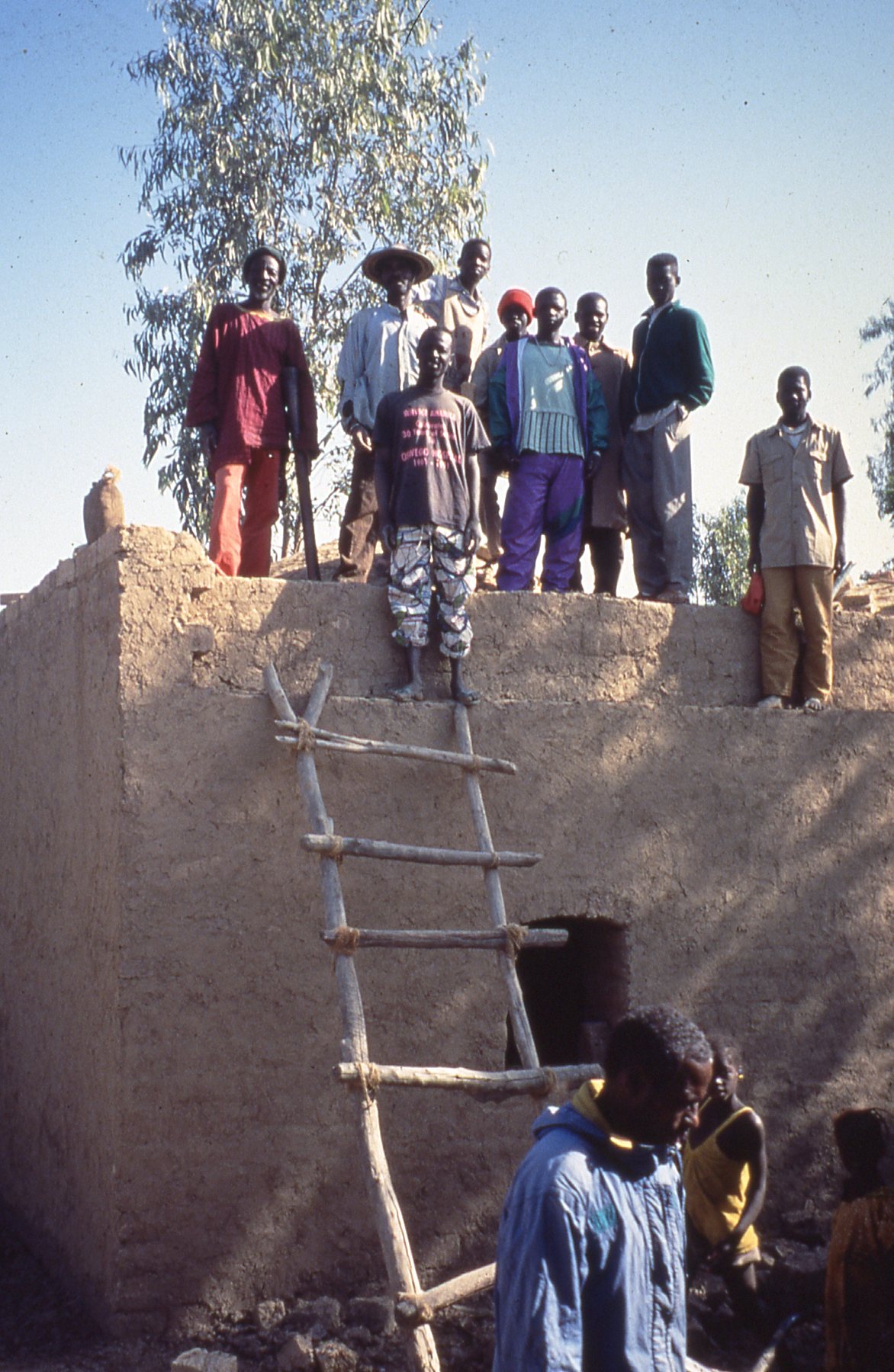 Men on roof with wooden ladder | DW Digital Archive